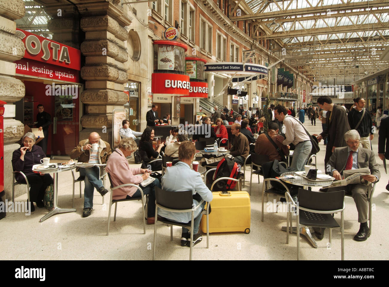 Waterloo railway terminal station concourse people sitting at snack bar ...