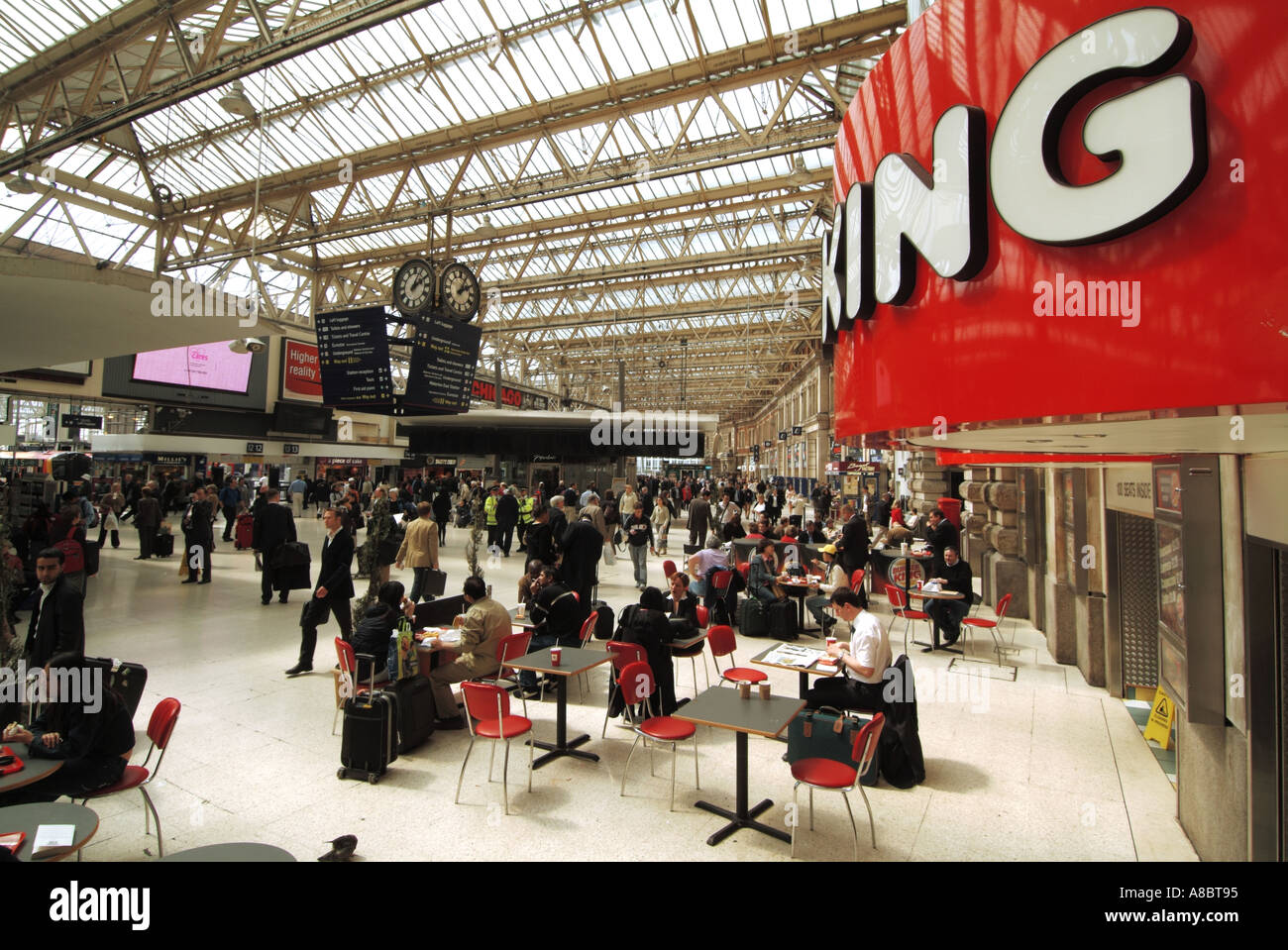 Waterloo railway terminal station concourse people sitting at snack bar ...