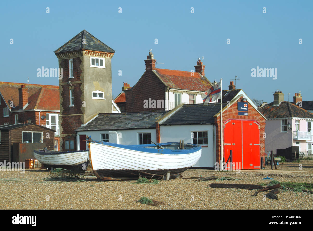 Aldeburgh beach with boats lifeboat station and seafront properties ...