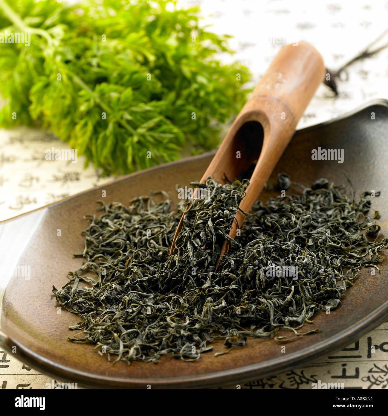 Tea leaves on the plate and tea digger Oriental tea stuff Stock Photo ...