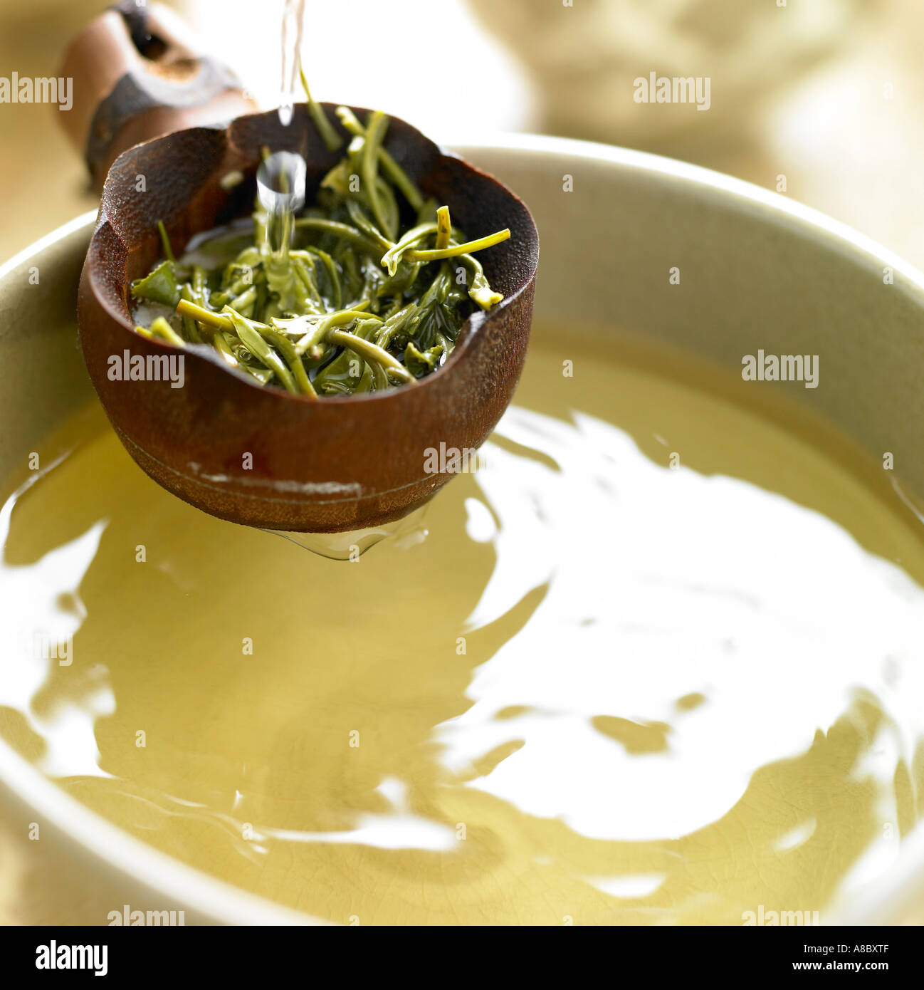 Tea filer with green tea leaves and large bowl Stock Photo - Alamy