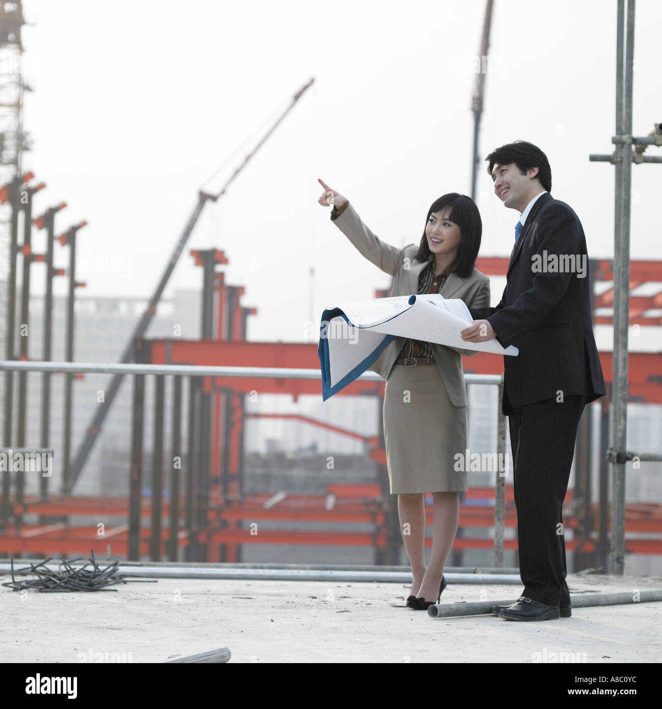 at a construction place architects discussing about a plan Stock Photo ...