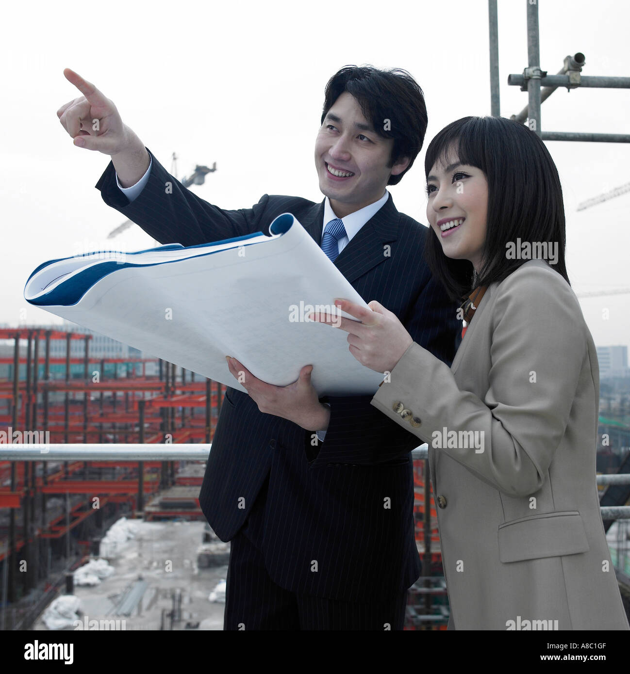 at a construction place architects discussing about a plan Stock Photo ...