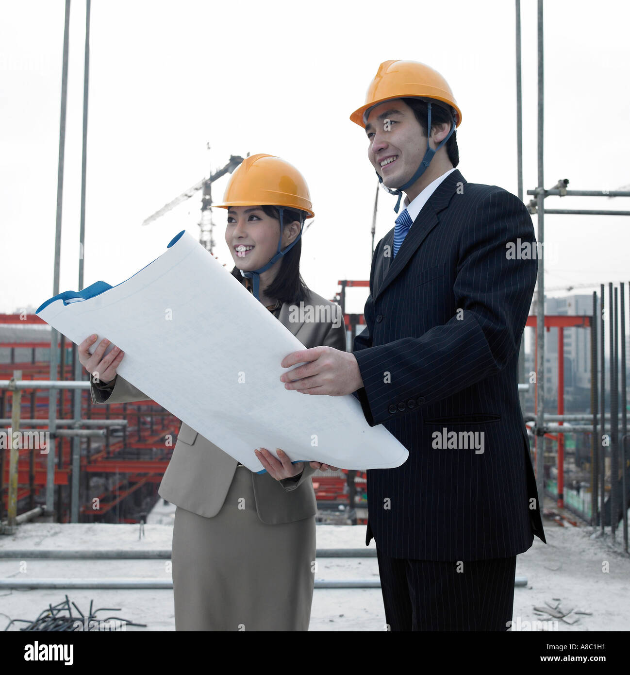 at a construction place architects discussing about a plan Stock Photo ...