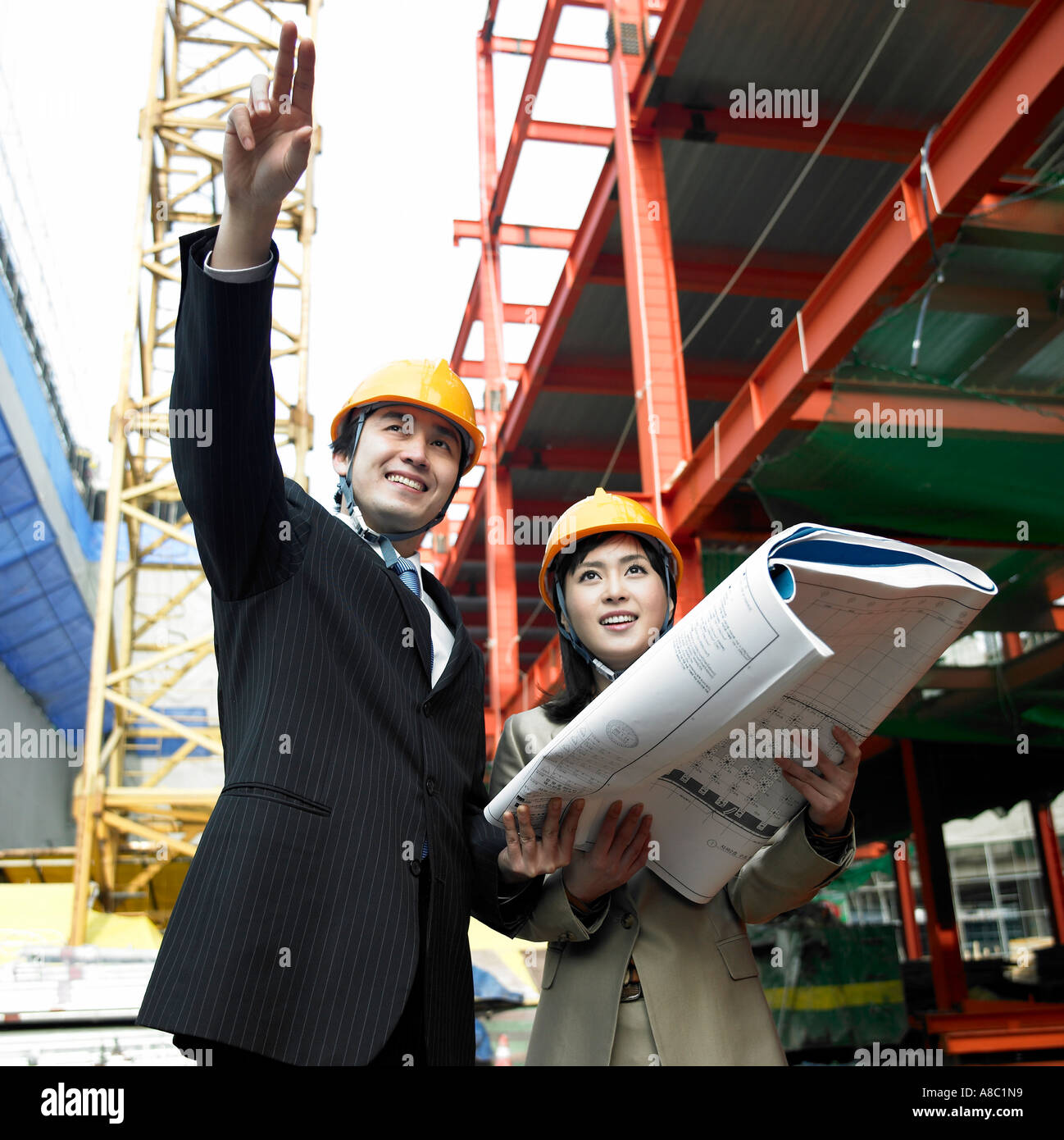 at a construction place architects discussing about a plan Stock Photo ...