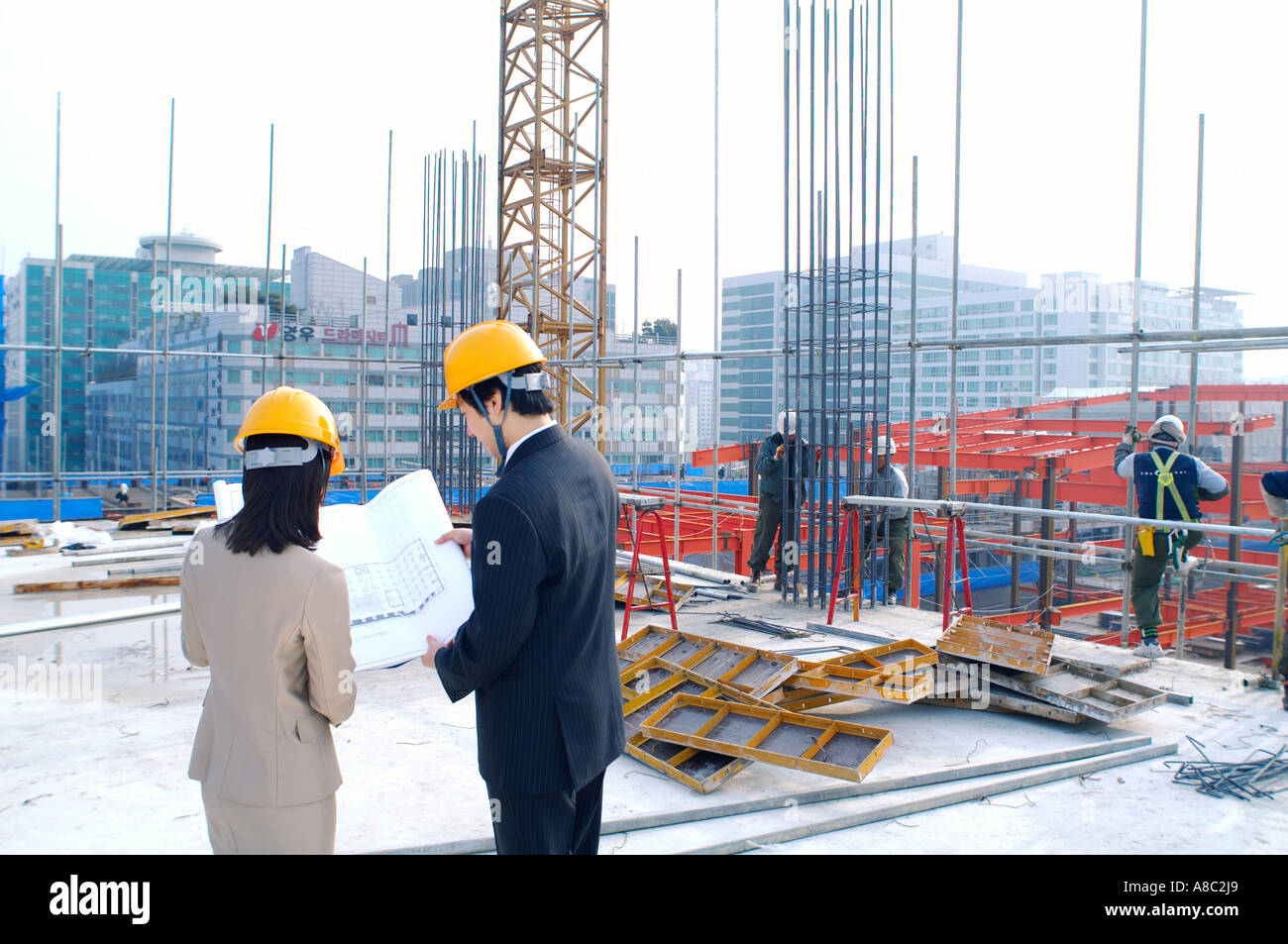 at a construction place architects looking at a plan Stock Photo - Alamy