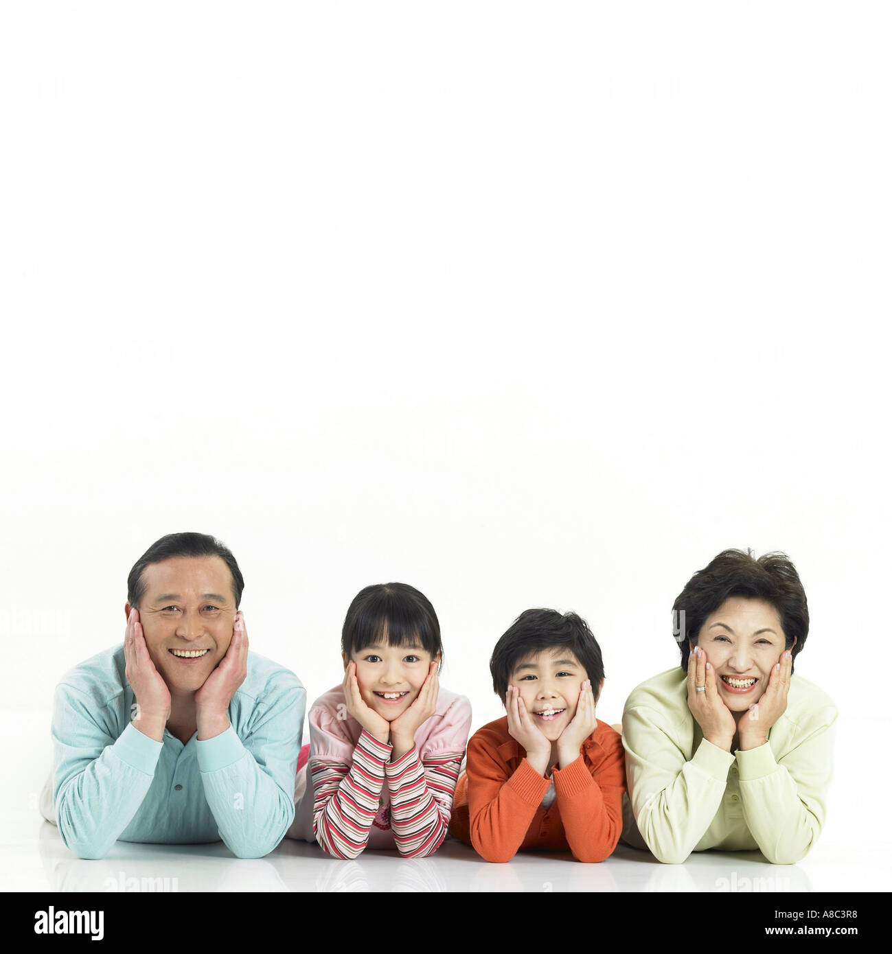 Family a family with their chins resting on the hand lying prone Stock ...