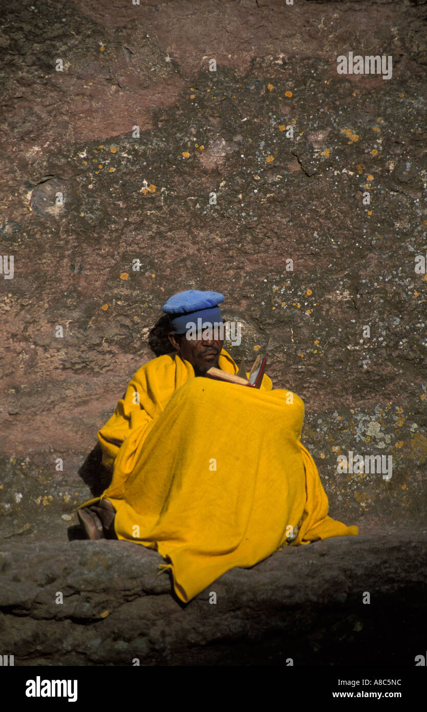 Monk reading his bible outside a rock-hewn church, Lalibela, Ethiopia ...