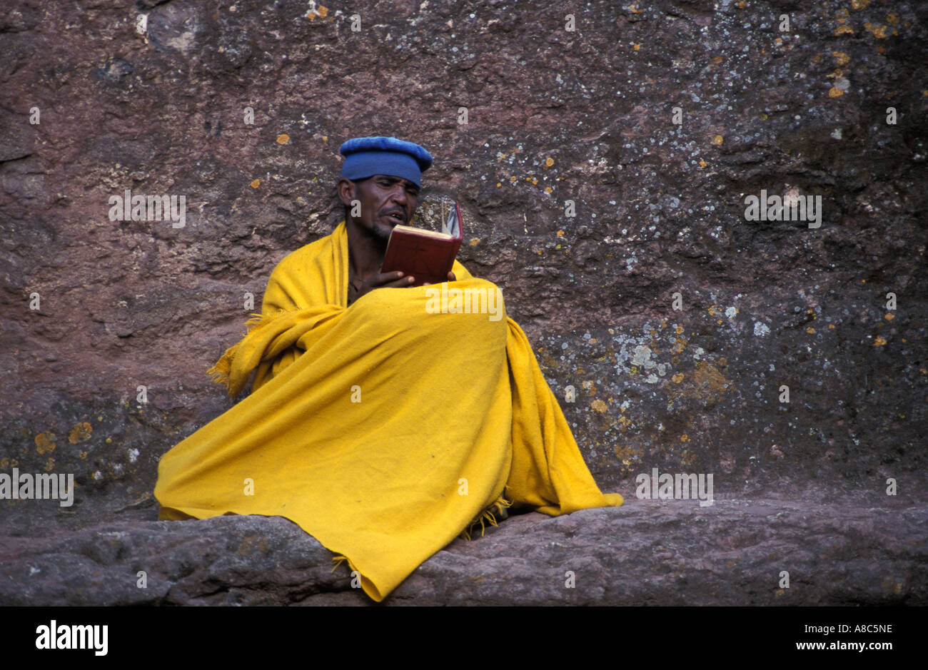 Monk reading his bible outside a rock-hewn church, Lalibela, Ethiopia ...