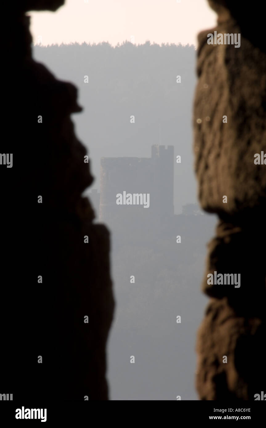 A misty view of a castle through the arrow slit of another castle ...