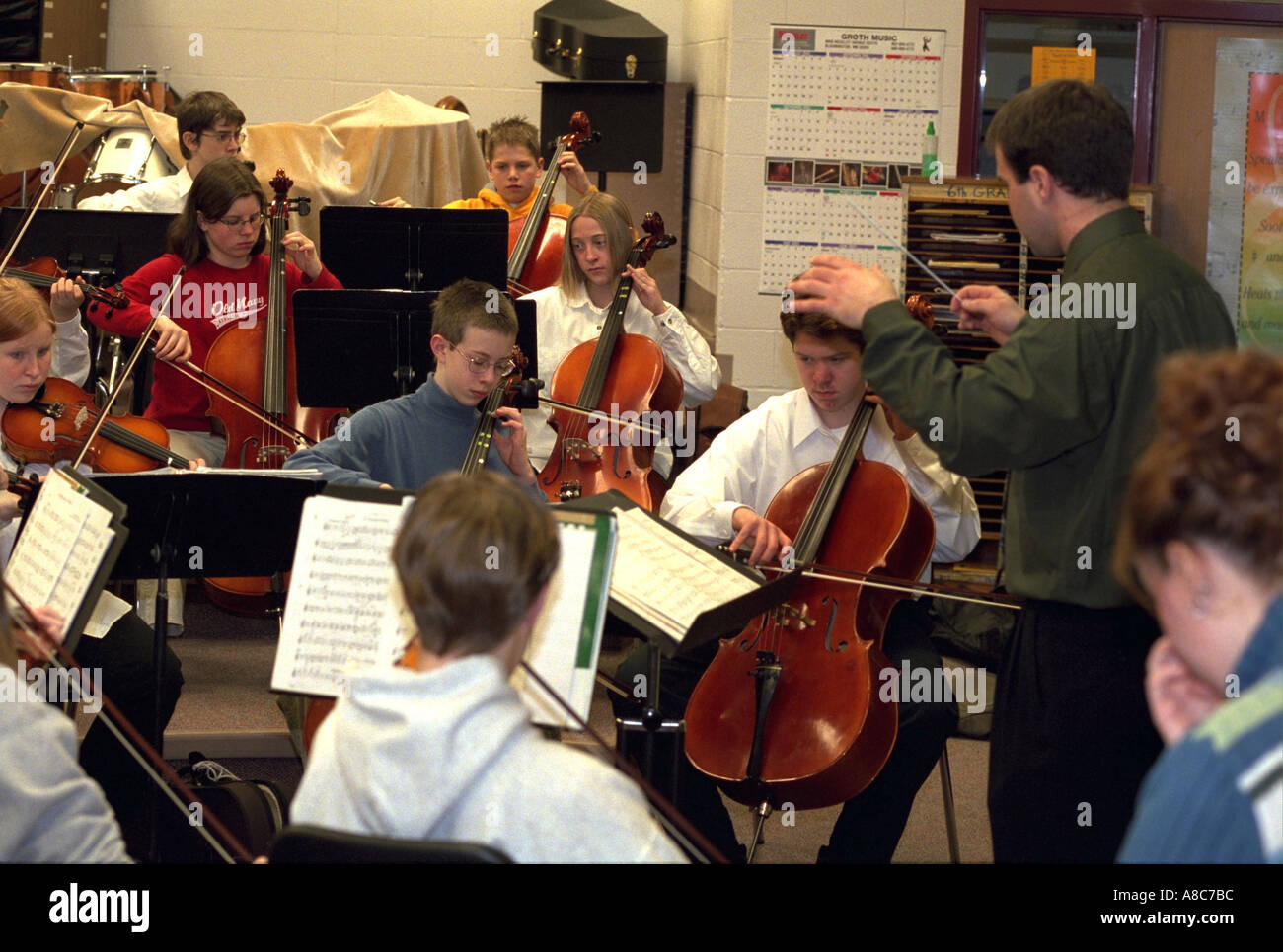 School orchestra rehearsing for school performance age 13. Golden ...
