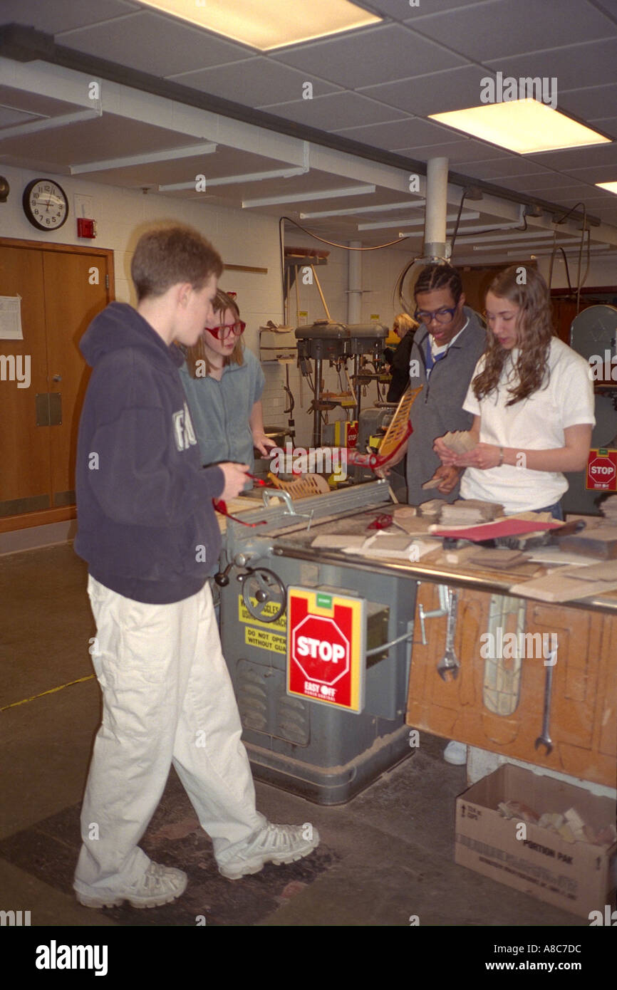 Students age 14 running project thru power circular saw in school shop ...