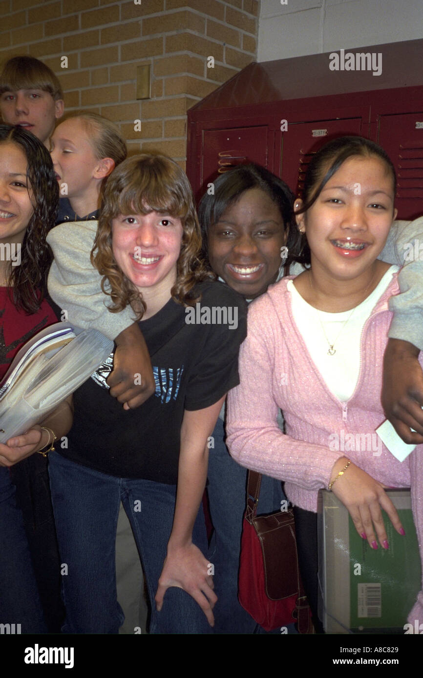 Friends posing for camera by lockers in school hallway. Golden Valley ...