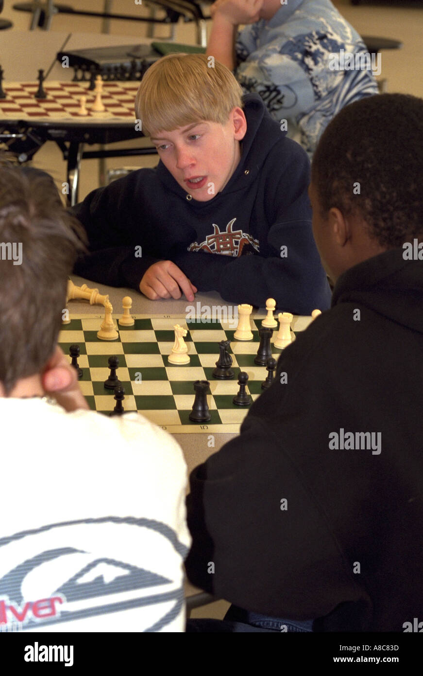 Students watching and learning the game of chess in school study hall ...