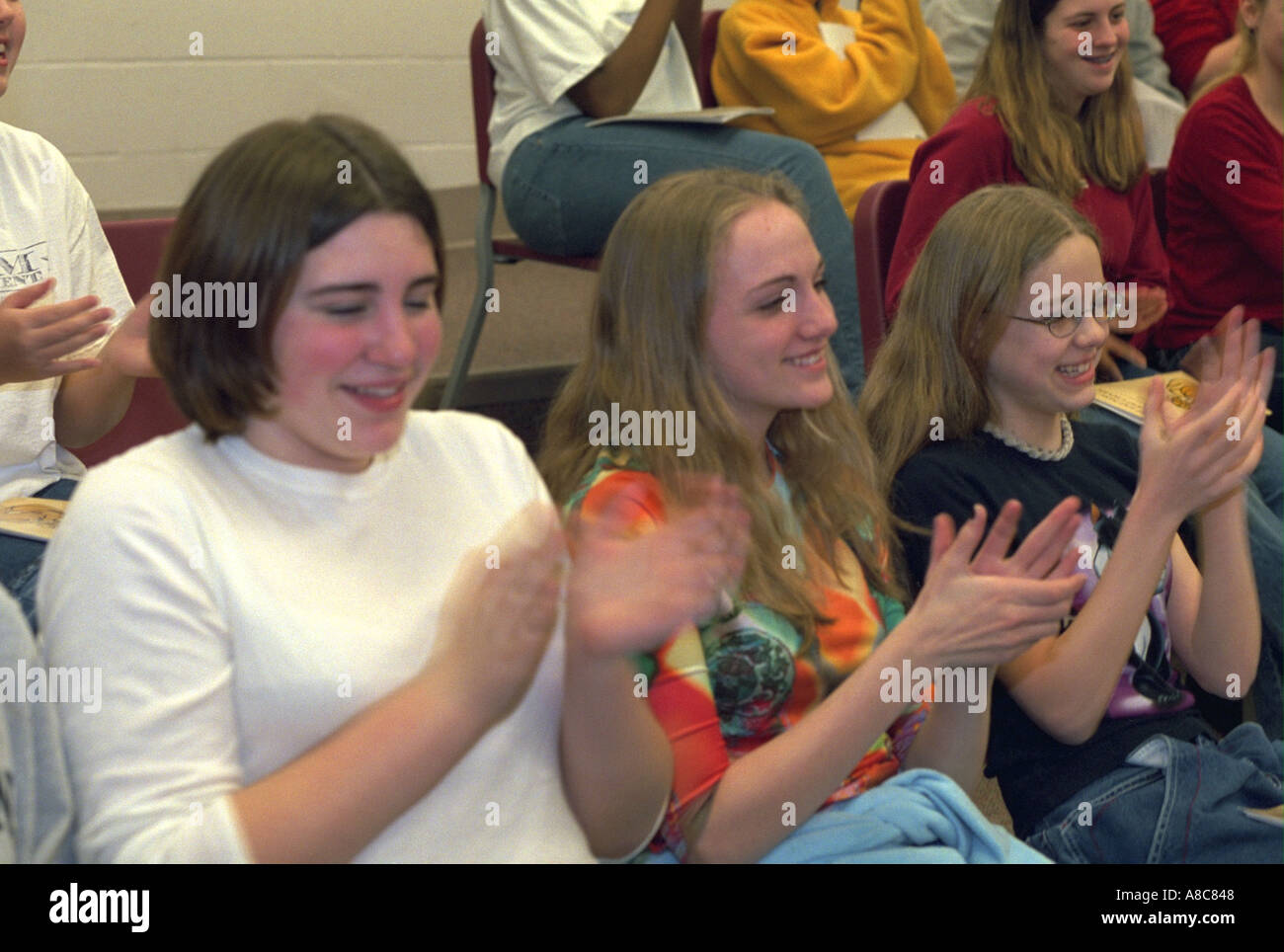 Students clapping during class at junior high school age 15. Golden ...
