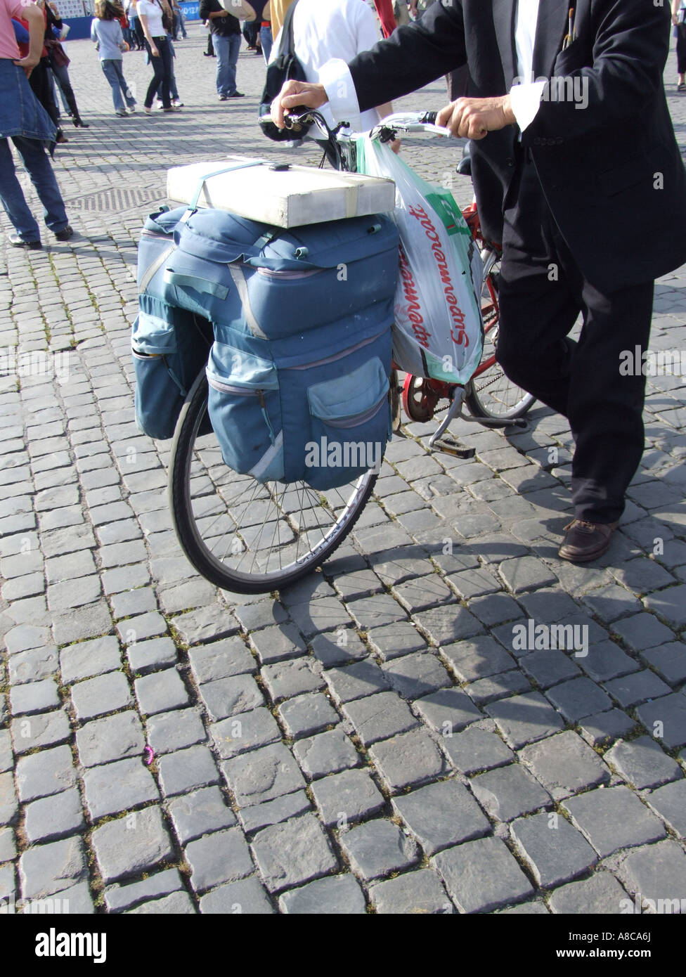 man carrying heavy load on push bike in rome Stock Photo - Alamy