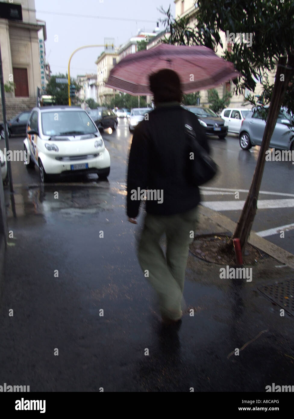 man crossing road in rain Stock Photo - Alamy