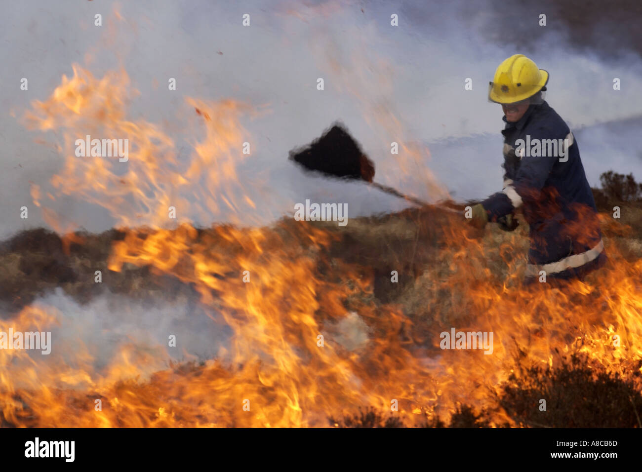 Fireman beating fire hi-res stock photography and images - Alamy