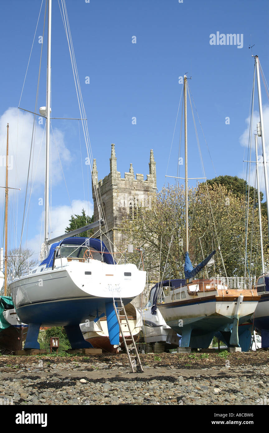 Yachts on hard in front of Church of St Anthony in Meneage Cornwall ...