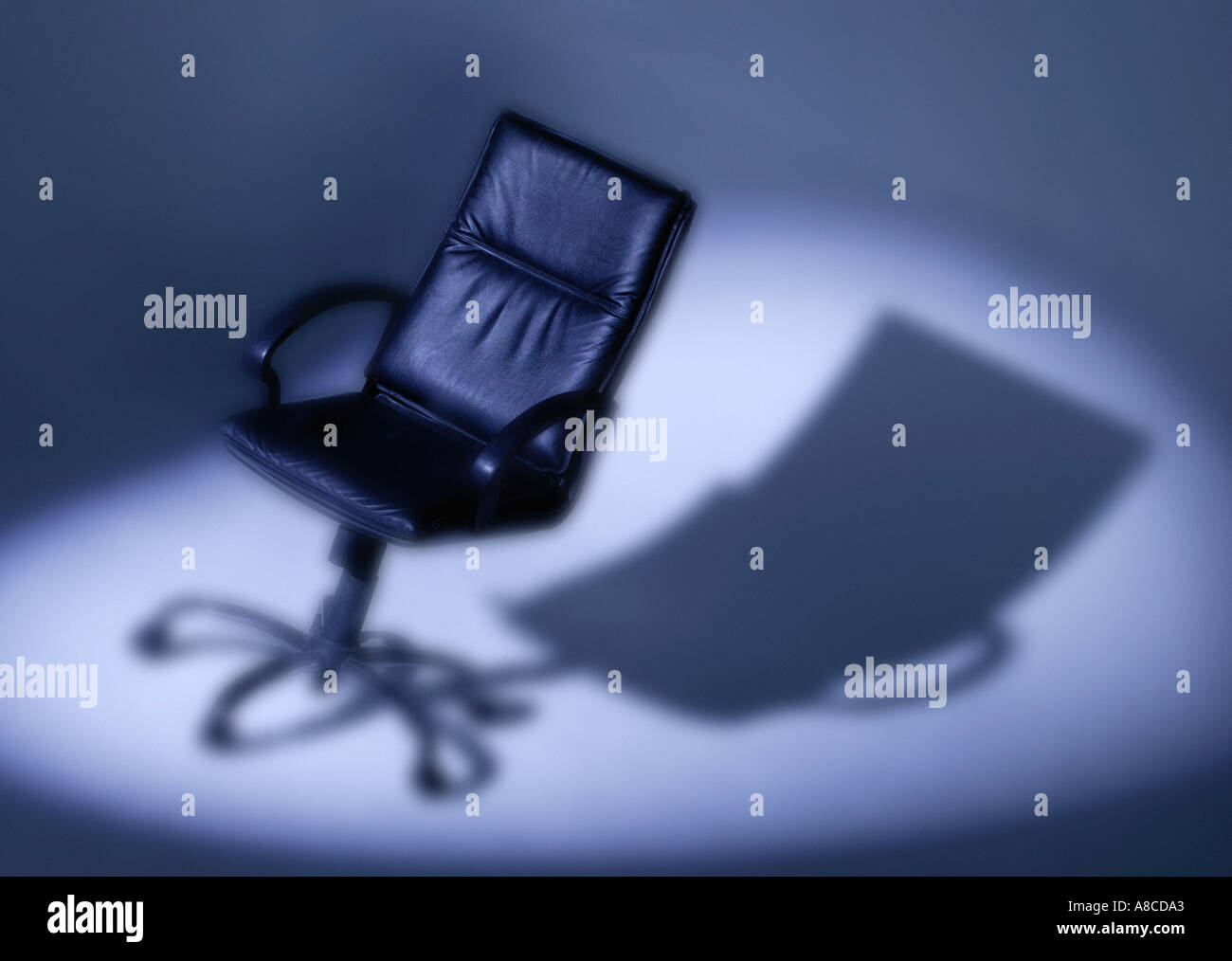 BLACK LEATHER OFFICE RECLINER CHAIR IN SPOTLIGHT Stock Photo - Alamy