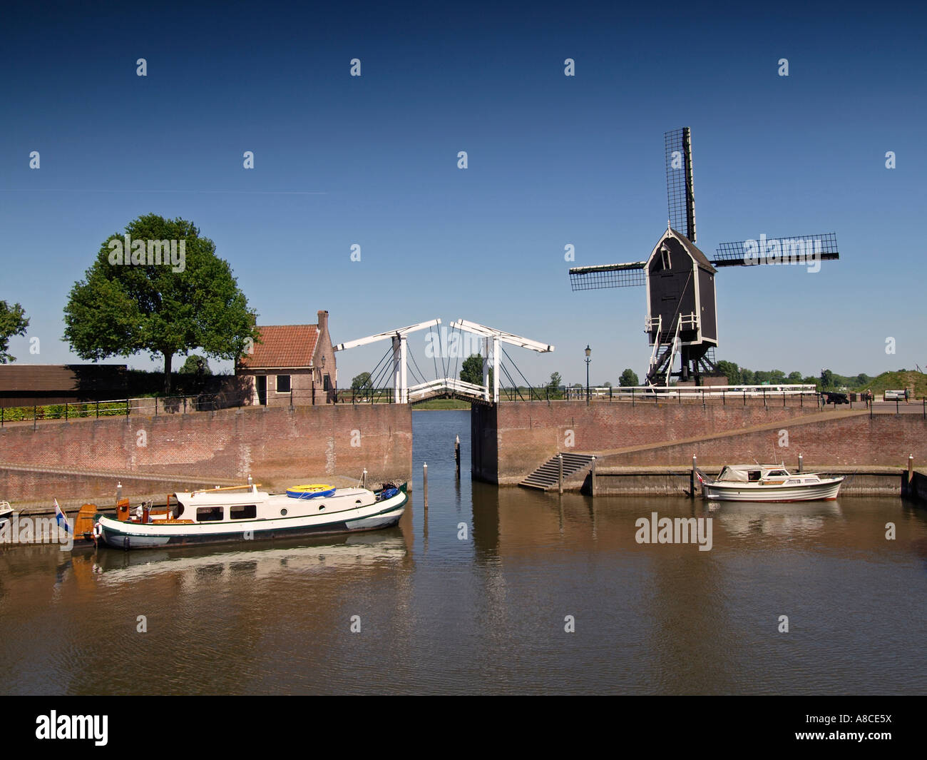 Windmill and boats in the port of the historic city of Heusden Noord ...