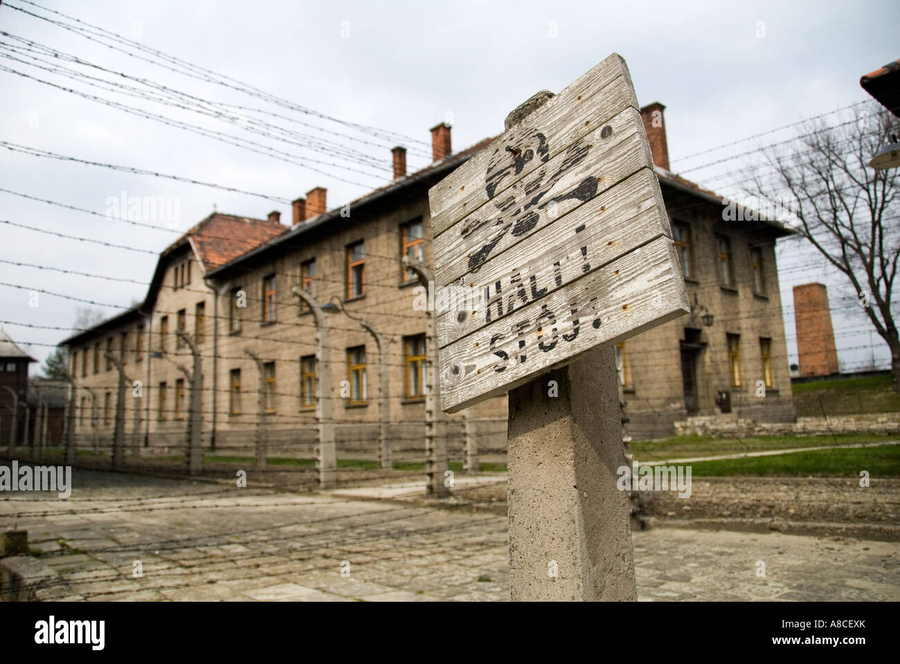 Auschwitz Halt Sigh with the SS hospital and Crematoria Stack in the ...
