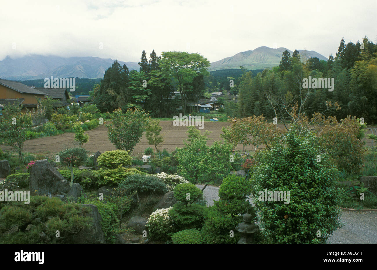 Panoramic view of Aso caldera with mount Aso volcano and a traditional ...
