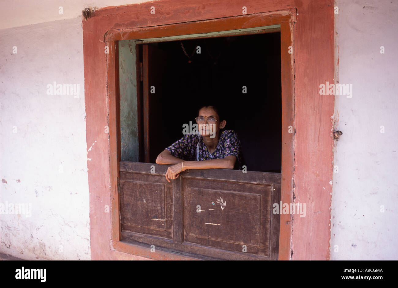 Woman leaning out of window hi-res stock photography and images - Alamy