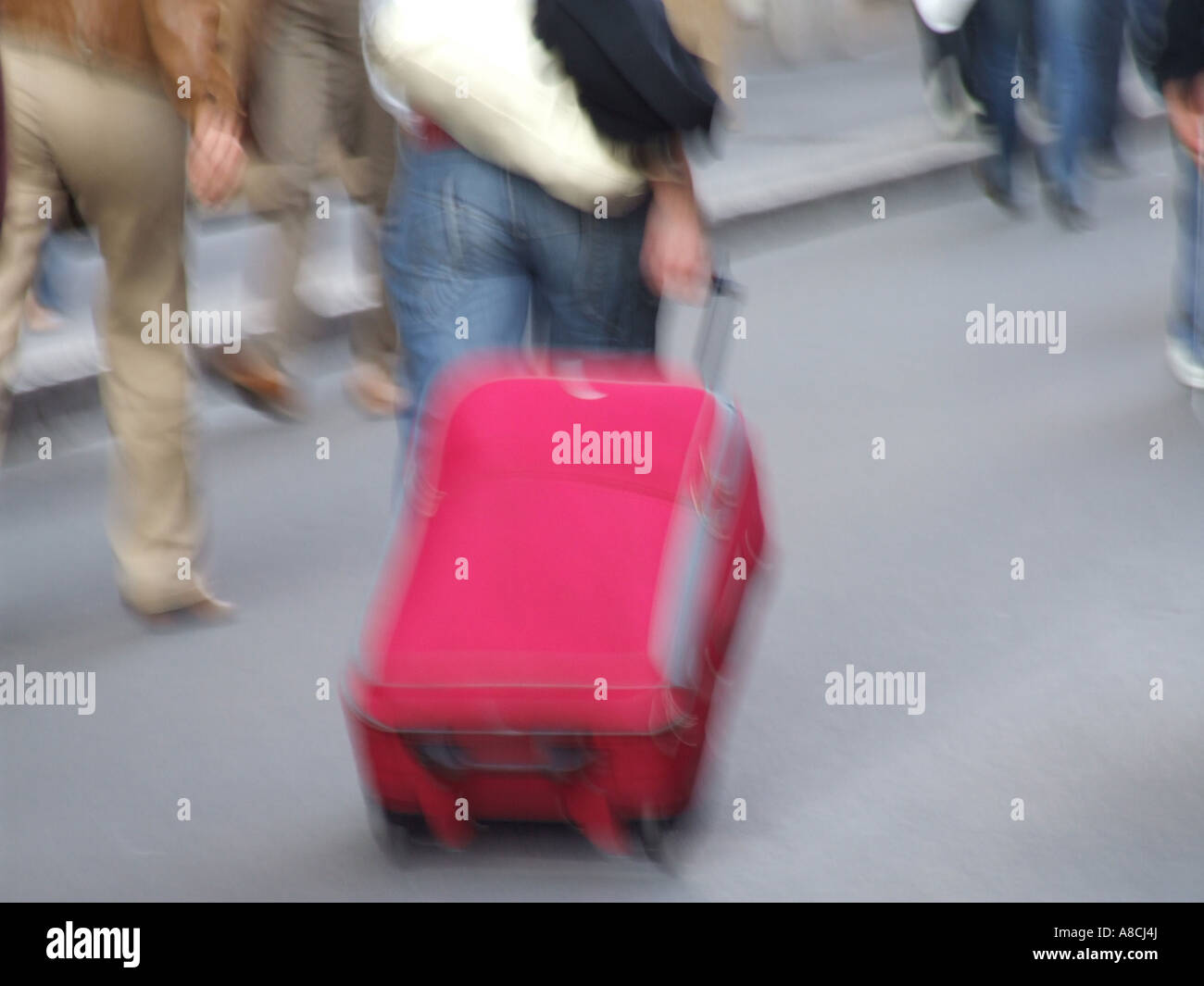 woman pulling trolley case in town Stock Photo - Alamy