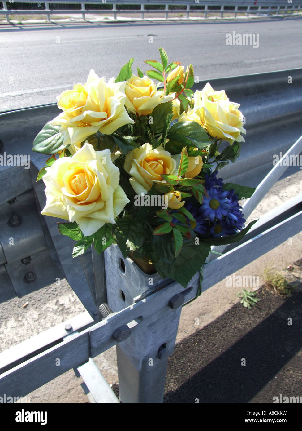 bunch of flowers left at fatal car crash scene Stock Photo - Alamy