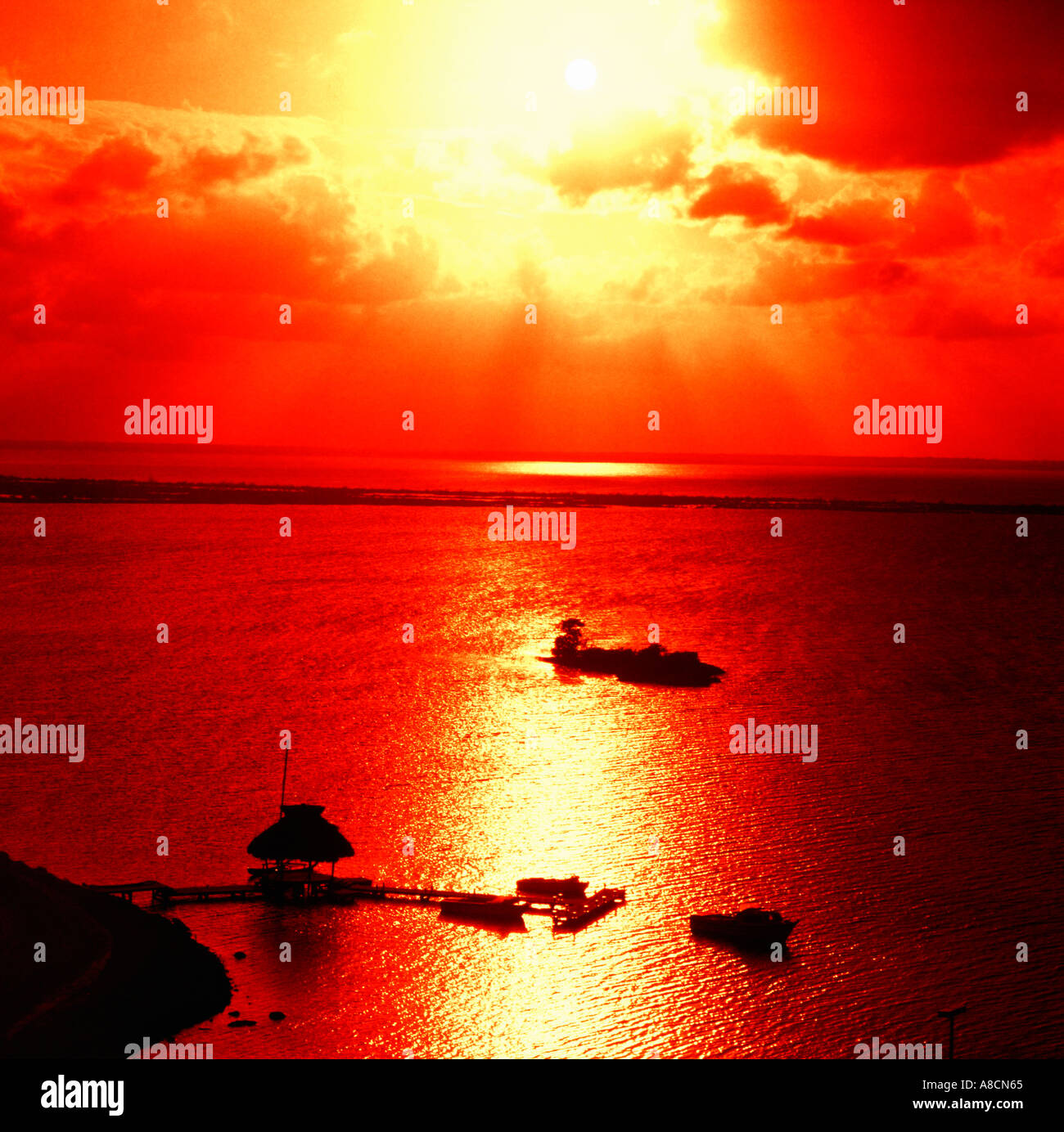 Brilliant sunset in Cancun in Mexico casts warm light onto the ocean ...