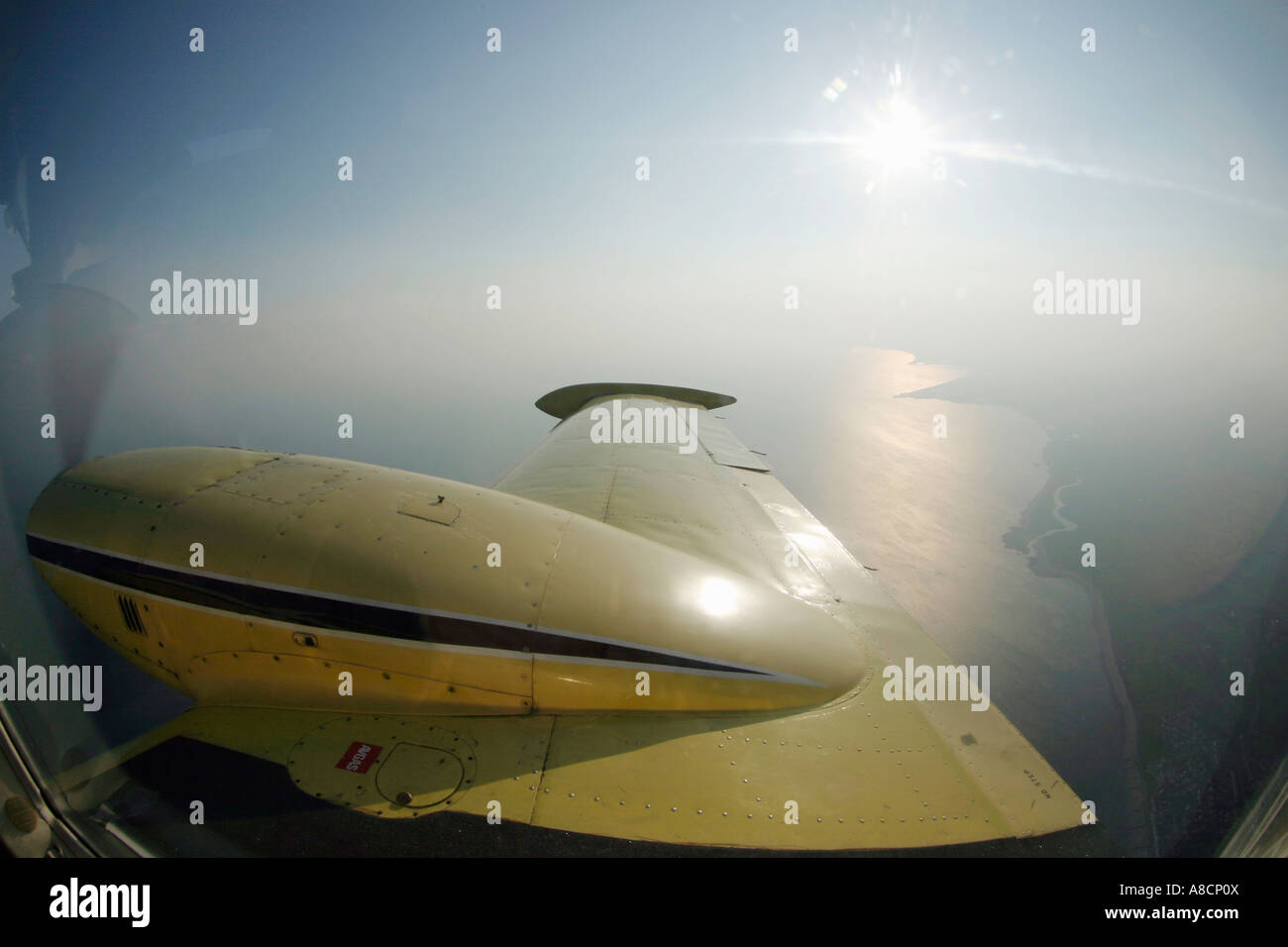 looking along wing of piper Comanche twin over Welsh coast somewhere ...