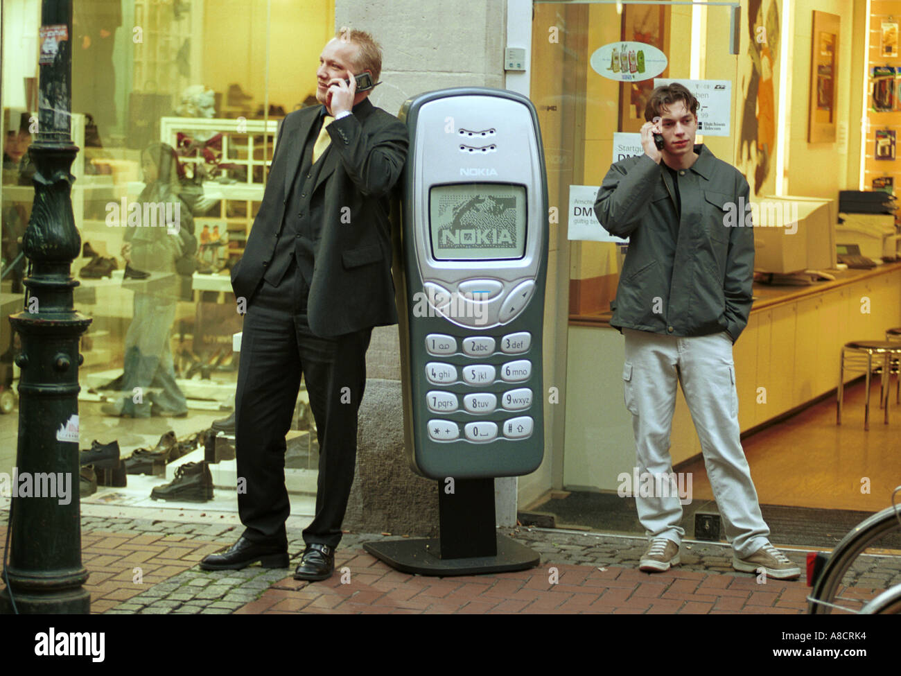 Men using mobile phones in Dusseldorf Germany Stock Photo - Alamy