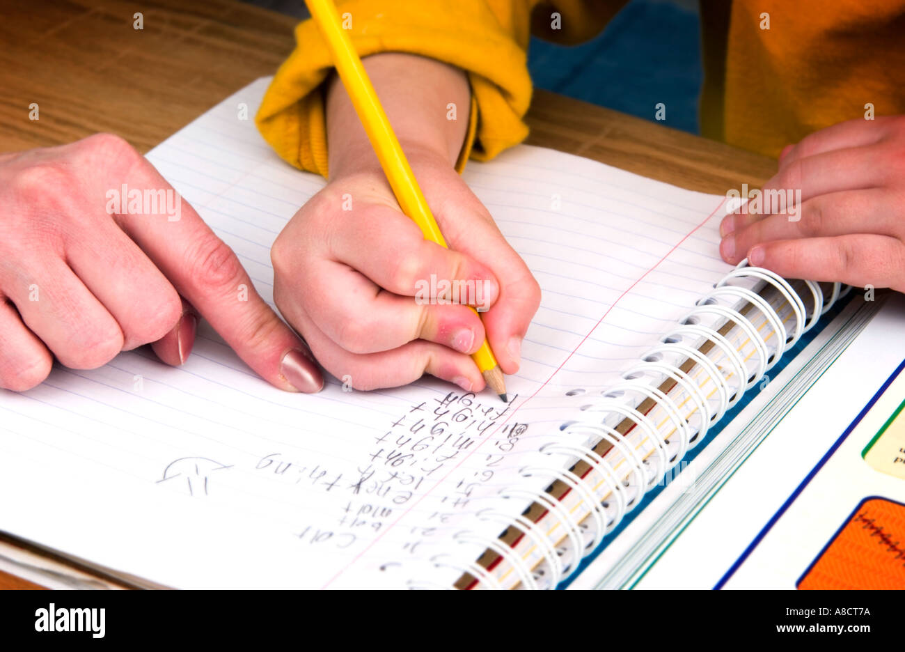Mother or teacher helping boy with homework Stock Photo - Alamy