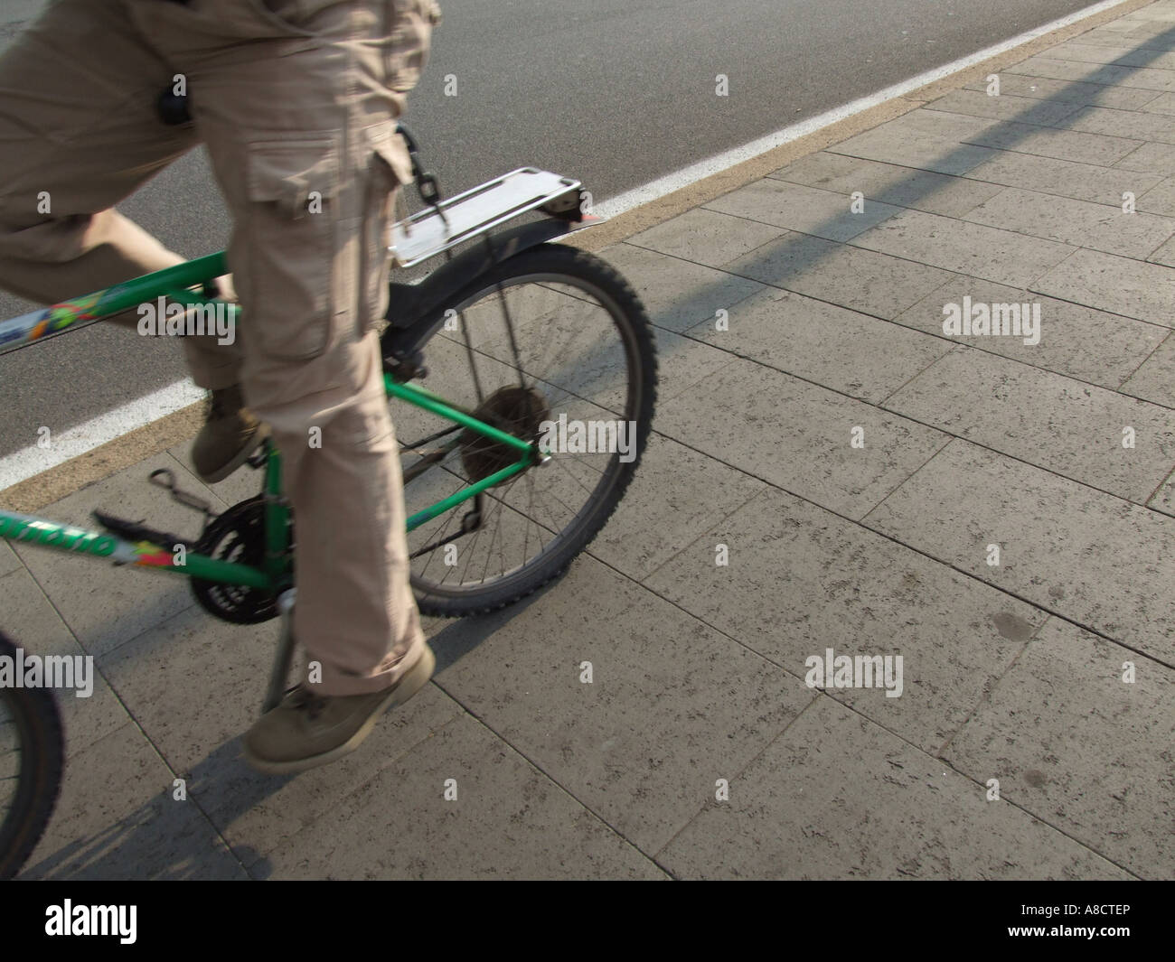 one person riding bike in city street Stock Photo - Alamy
