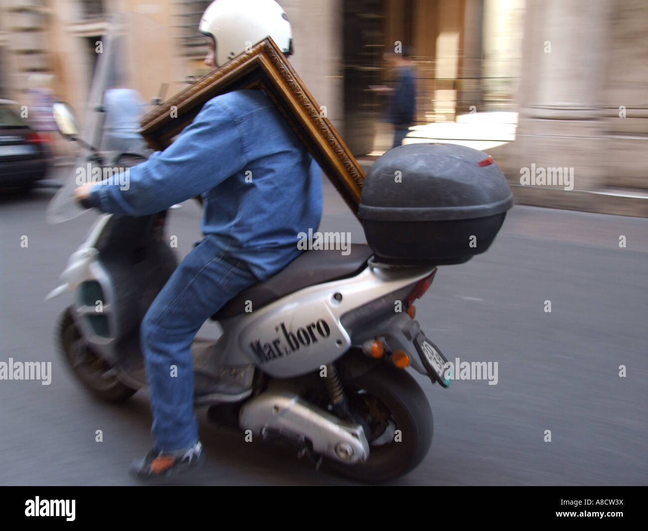 man carrying picture frame on motorbike in rome, italy Stock Photo - Alamy