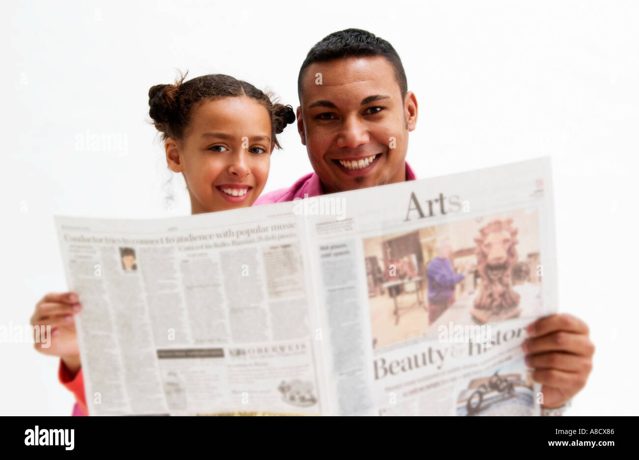 Father and daughter reading newspaper Stock Photo - Alamy