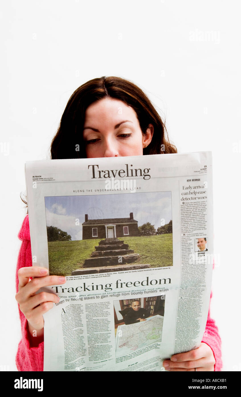 Woman reading newspaper Stock Photo - Alamy