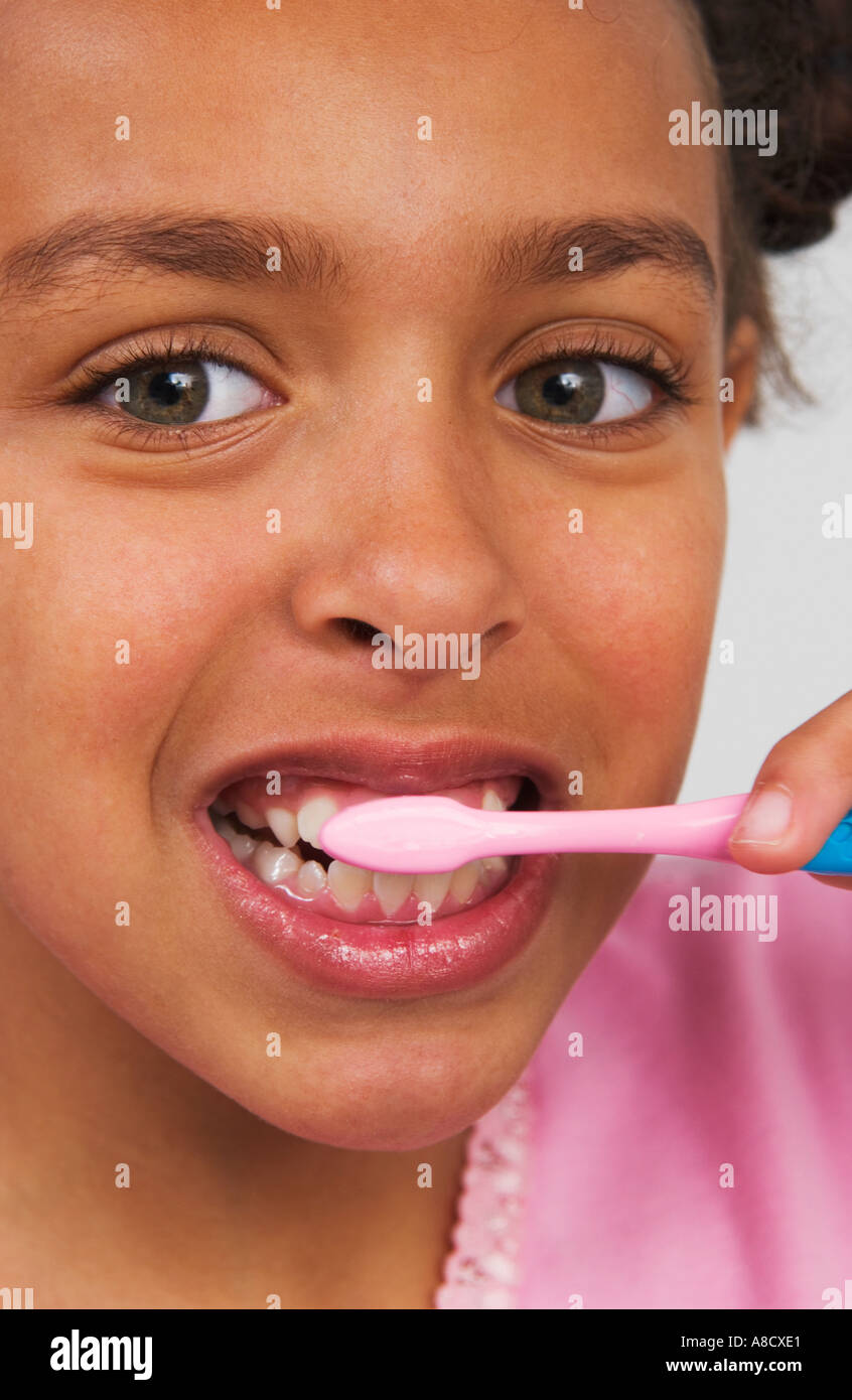 Young African American girl brushing teeth Stock Photo - Alamy