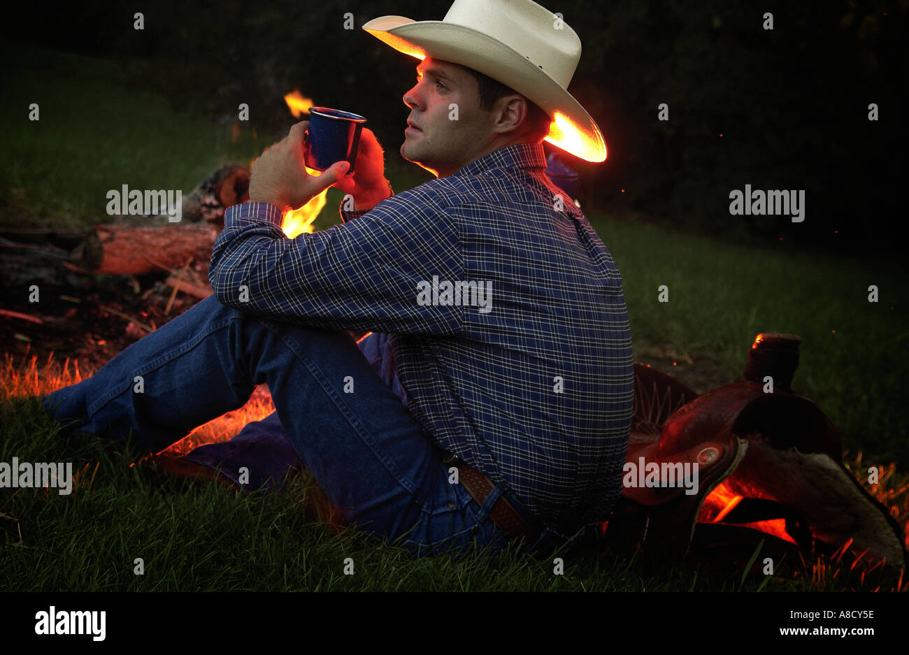 Cowboy near campfire Stock Photo - Alamy
