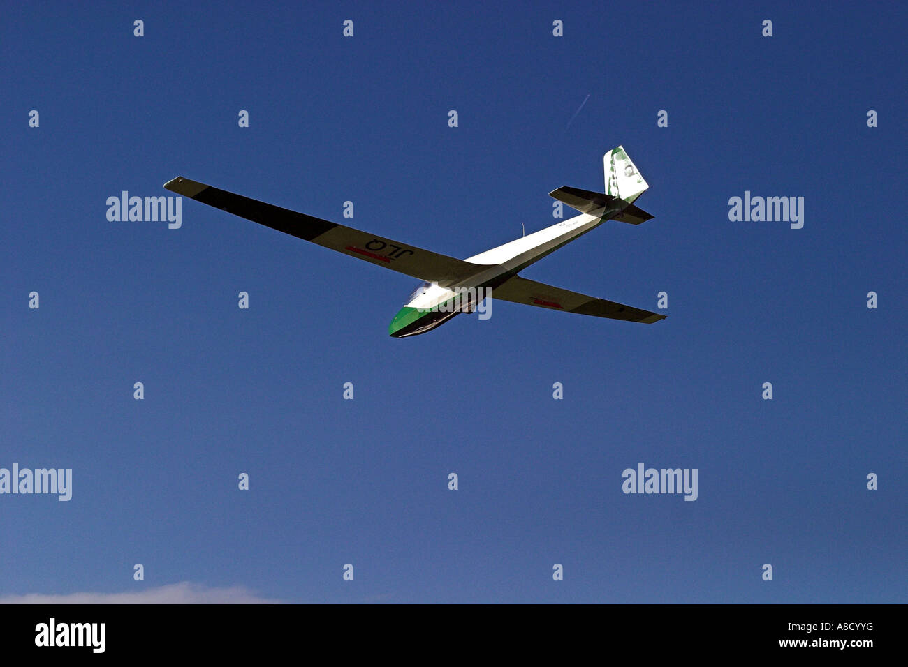 Glider soaring on thermal air currents under a cloudless blue sky ...