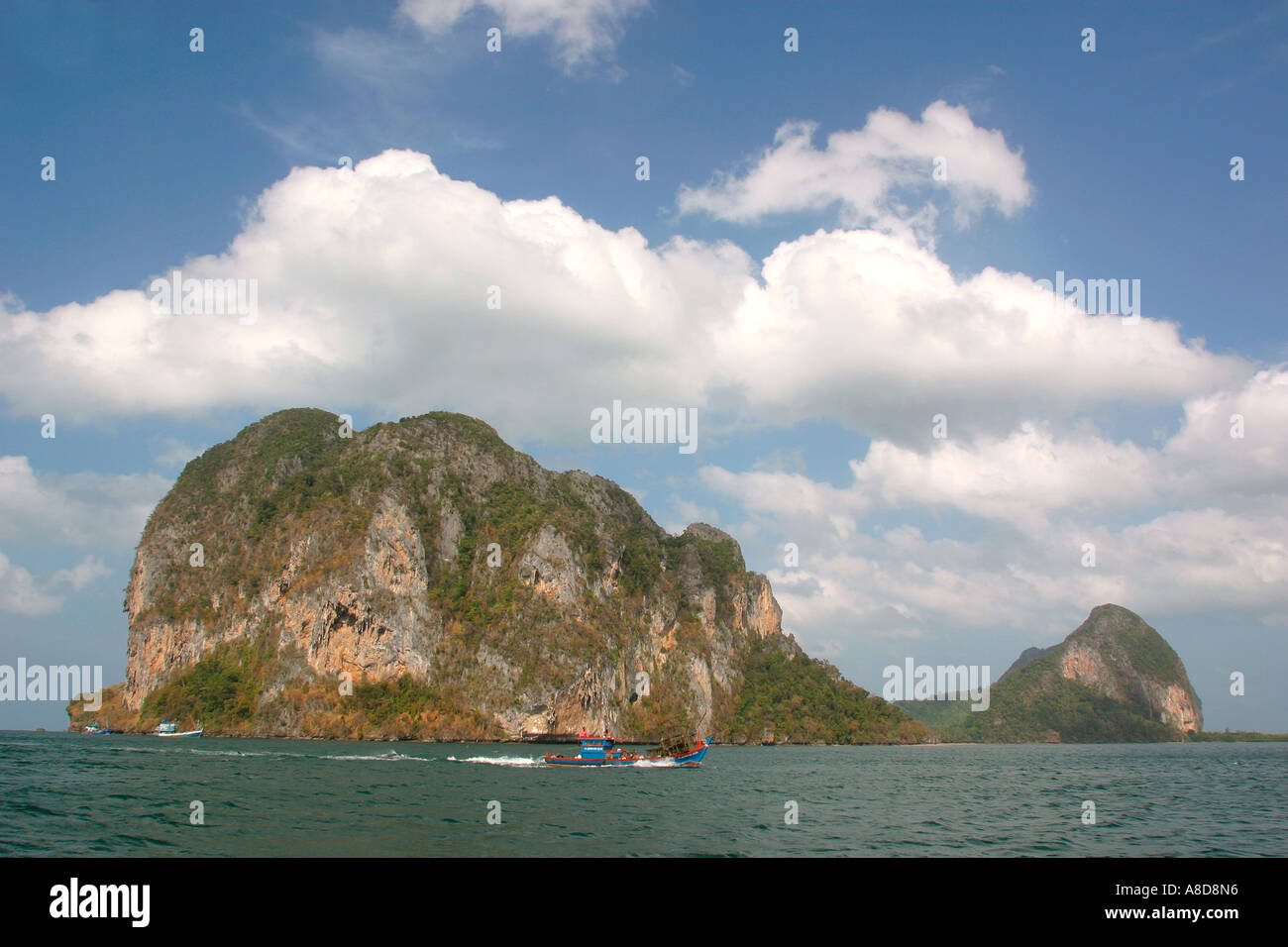 Thailand Trang Province Pak Meng rocky island and fishing boat Stock ...