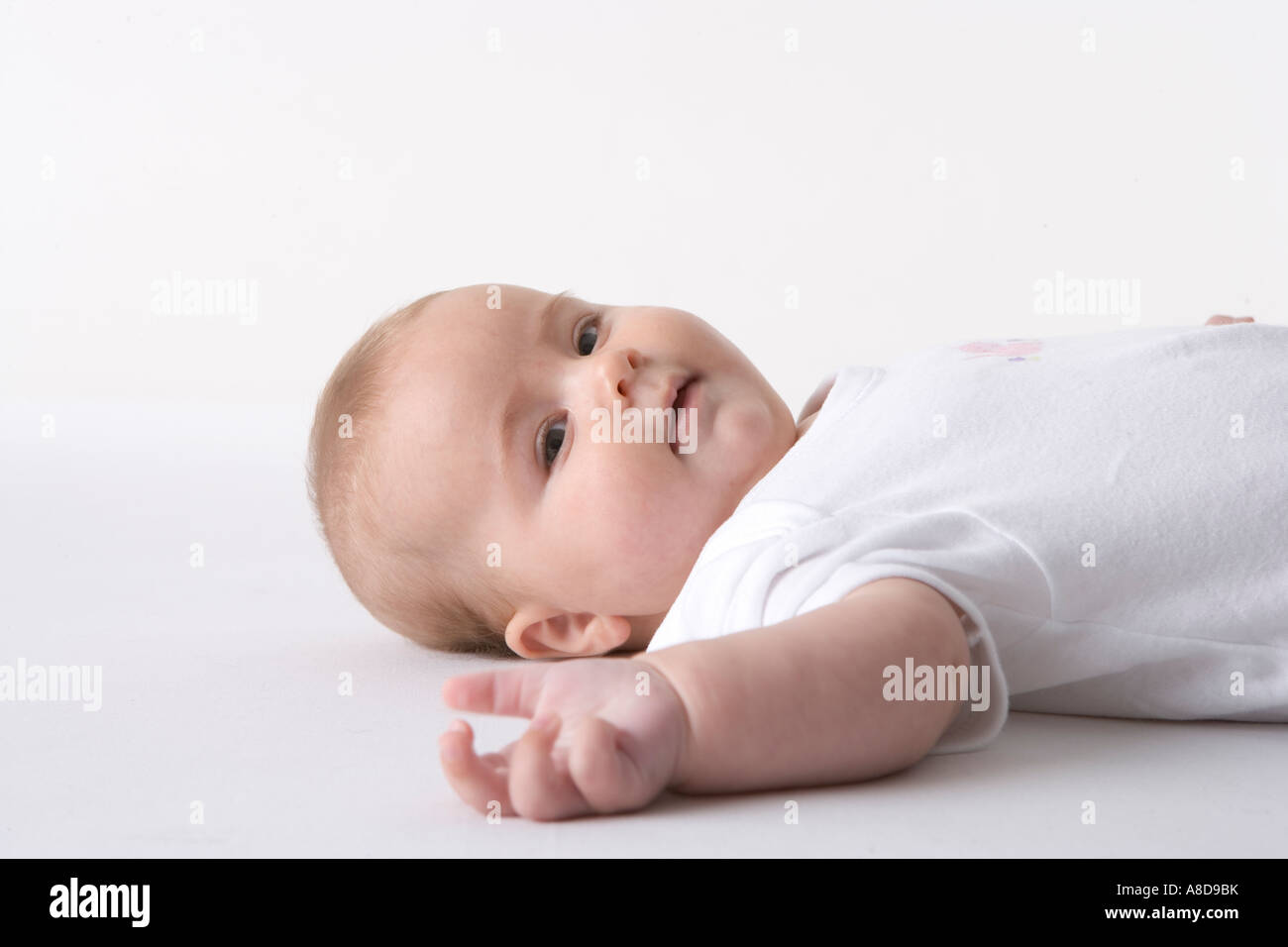 Little baby lying on the floor on her back Stock Photo - Alamy