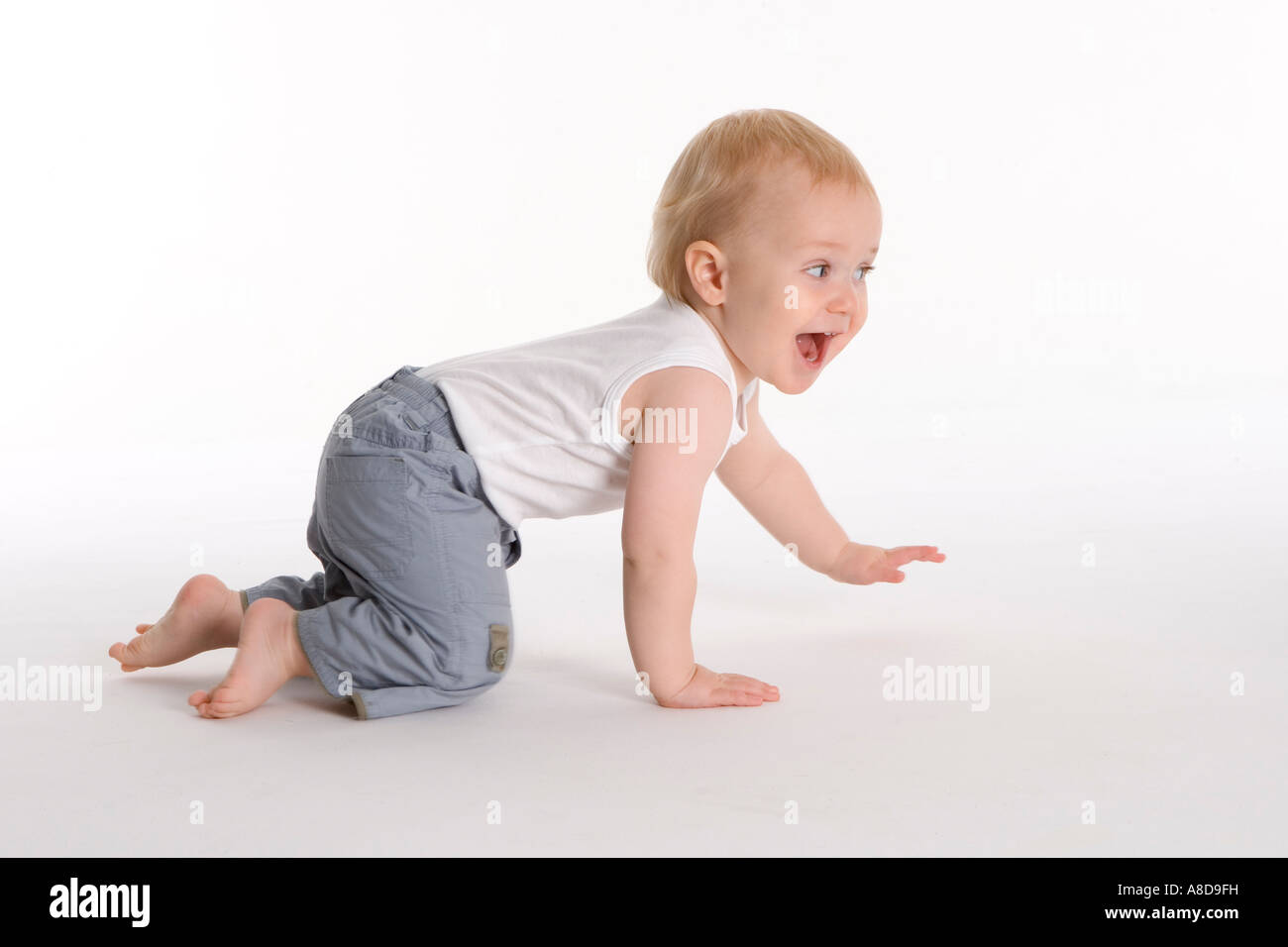 Crawling little boy crying of fun Stock Photo - Alamy