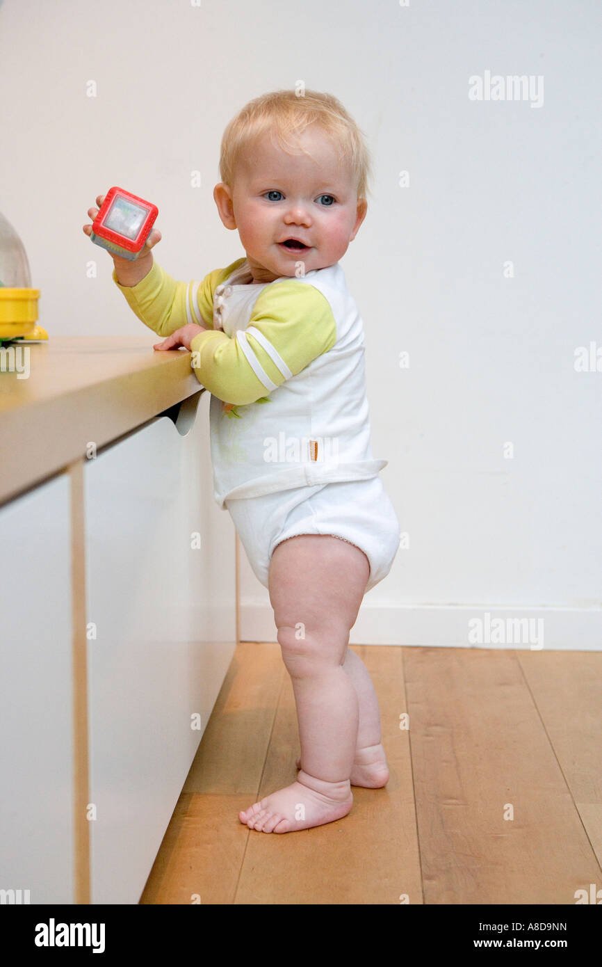 Child standing with a toy Stock Photo - Alamy