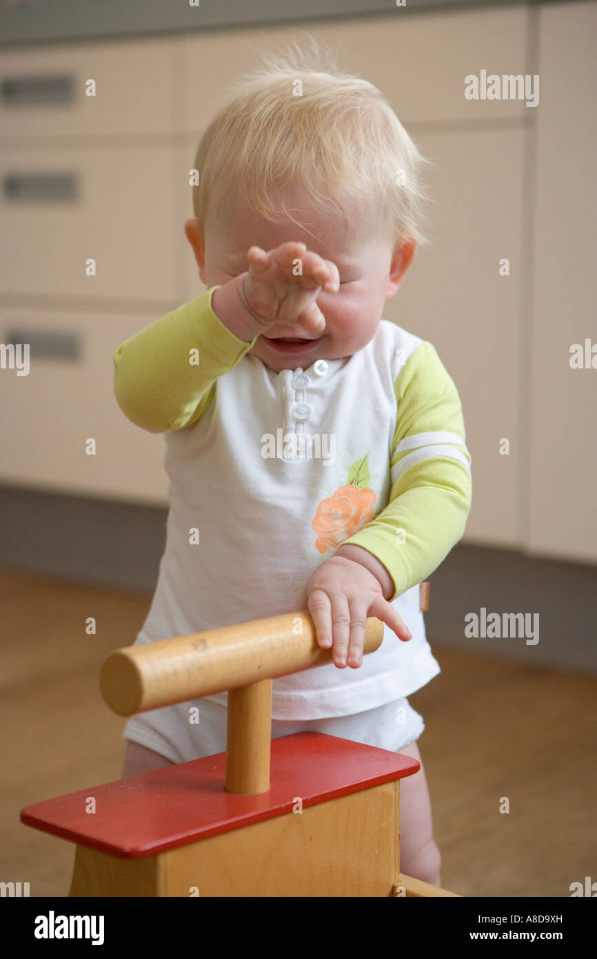 Tired child with a baby walker Stock Photo - Alamy