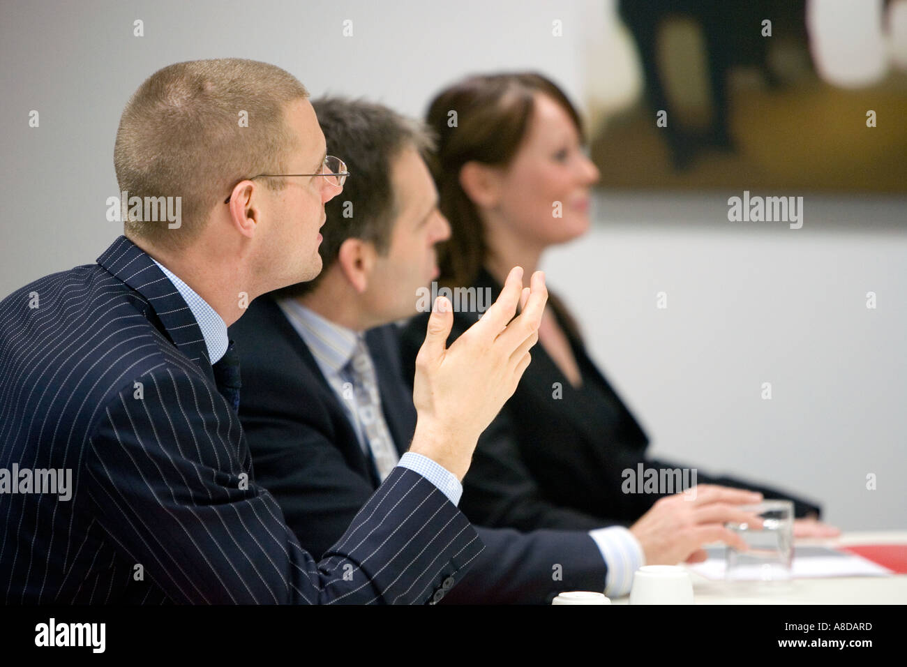 Businessmen posing for a commercial photoshoot in office boardroom ...
