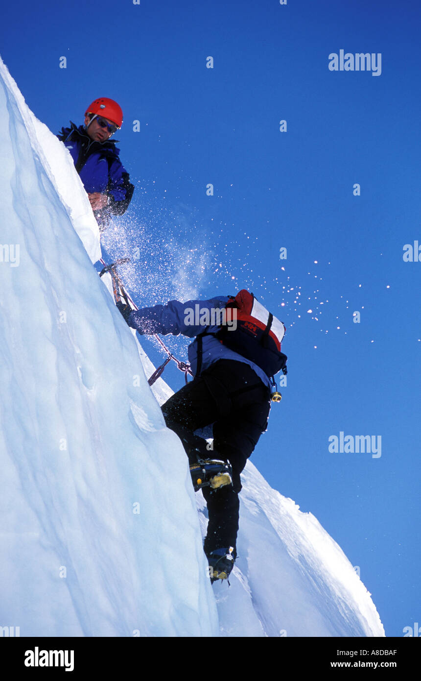 mountain guide with client climbing ice serac Stock Photo - Alamy