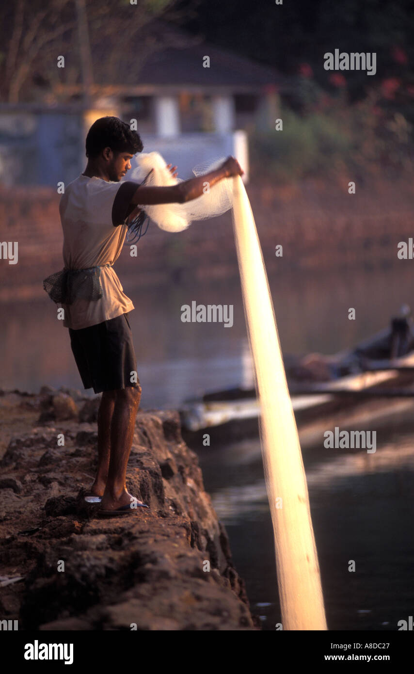 Young man pulling in net Goa India Stock Photo - Alamy