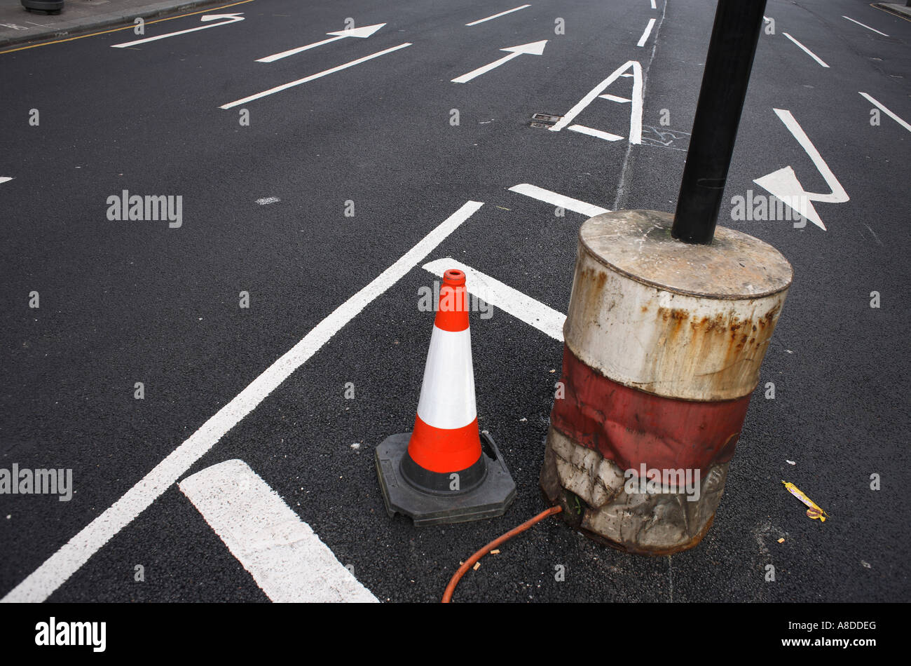 A newly painted road surface reveals a new cone, temporary traffic ...
